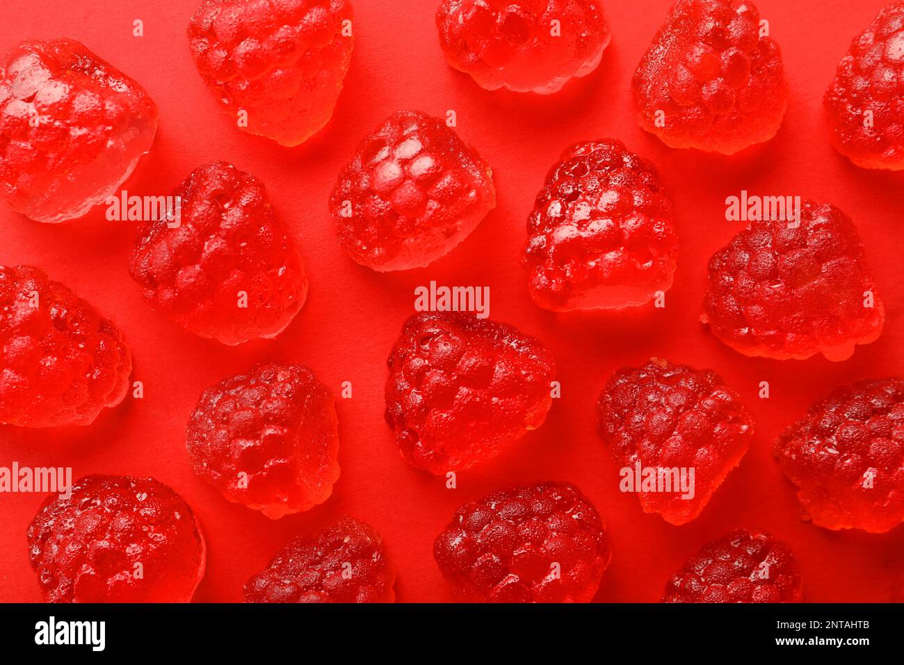 Delicious gummy raspberry candies on red background, flat lay Stock ...