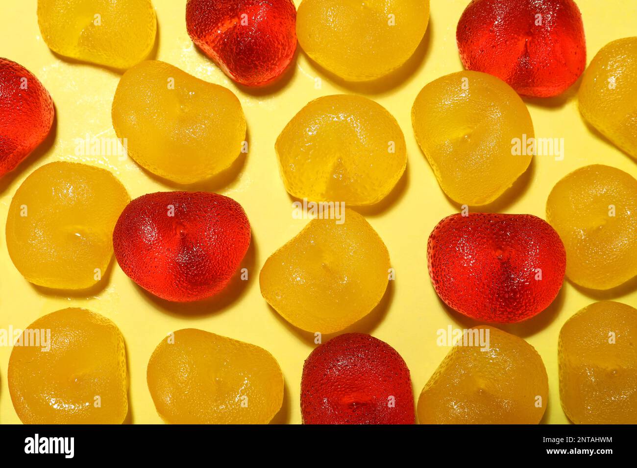Delicious gummy cherry candies on yellow background, flat lay Stock ...