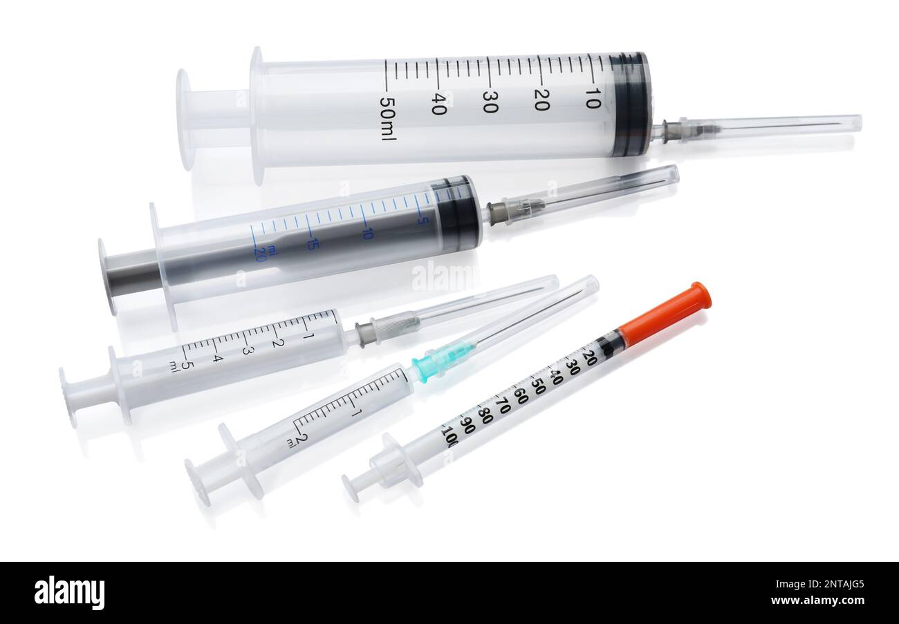 Different disposable syringes with needles on white background Stock ...