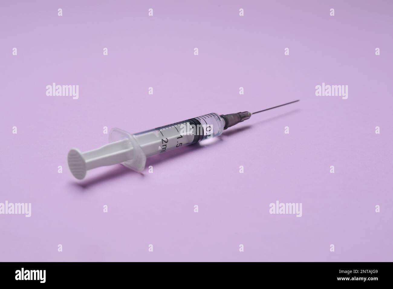 Disposable syringe with needle and medicine on violet background Stock ...