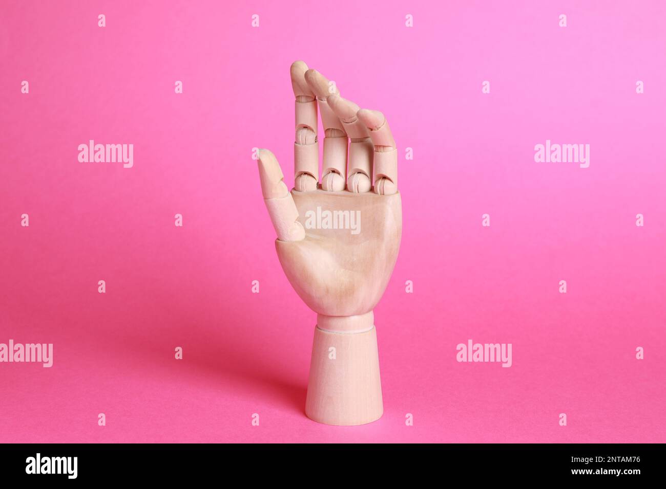Wooden hand model on pink background. Mannequin part Stock Photo - Alamy