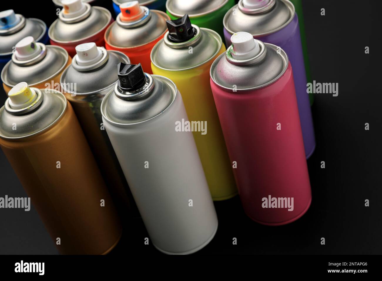 Cans of different graffiti spray paints on black background Stock Photo ...