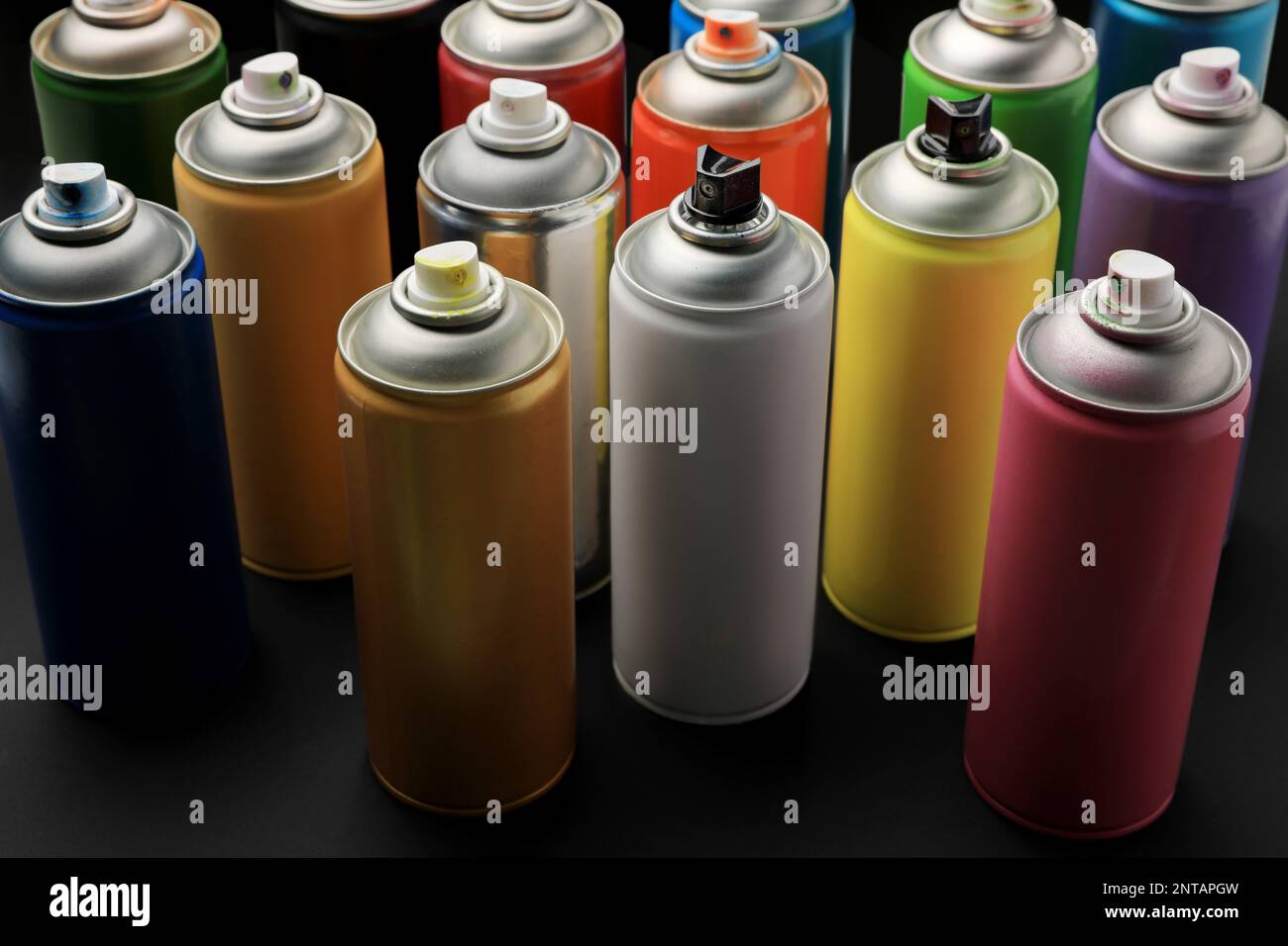 Cans of different graffiti spray paints on black background Stock Photo ...