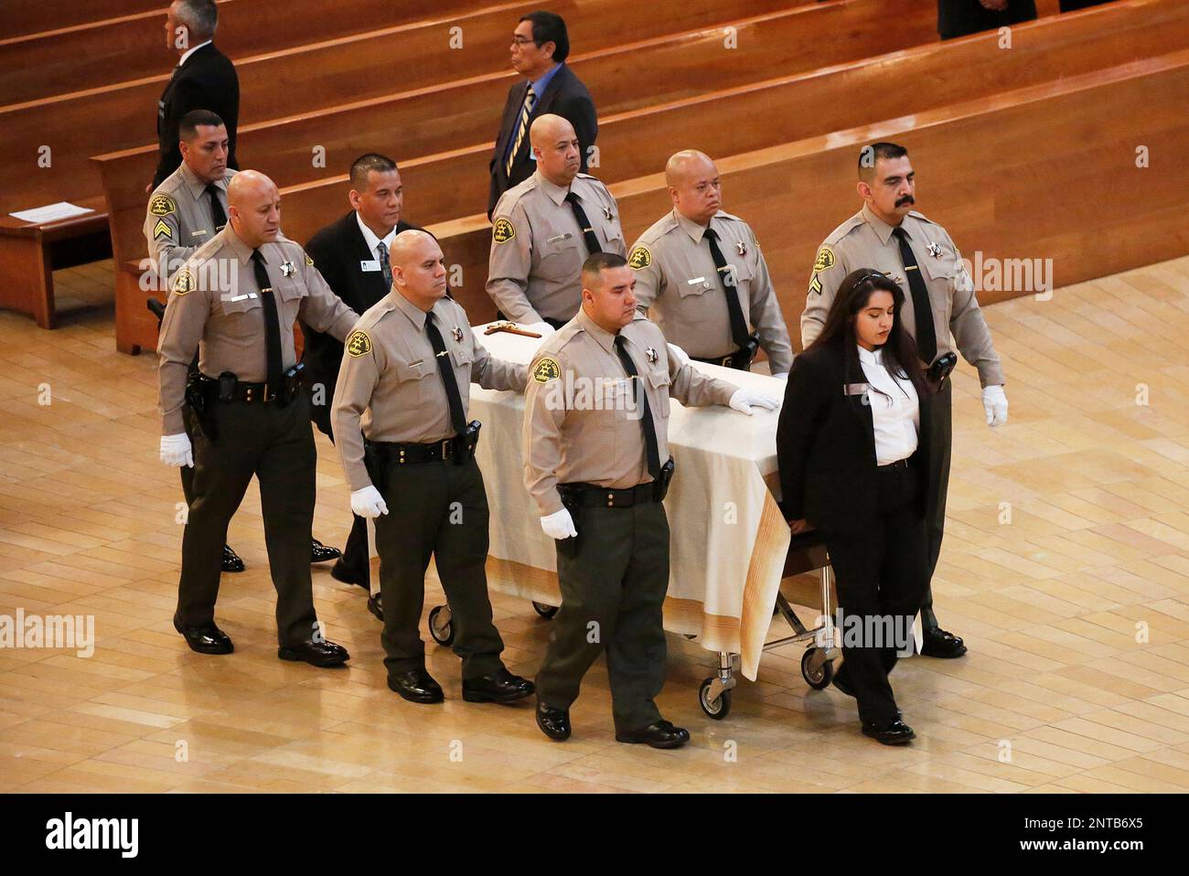 Los Angeles County Sheriff deputies as pallbearers deliver the casket ...