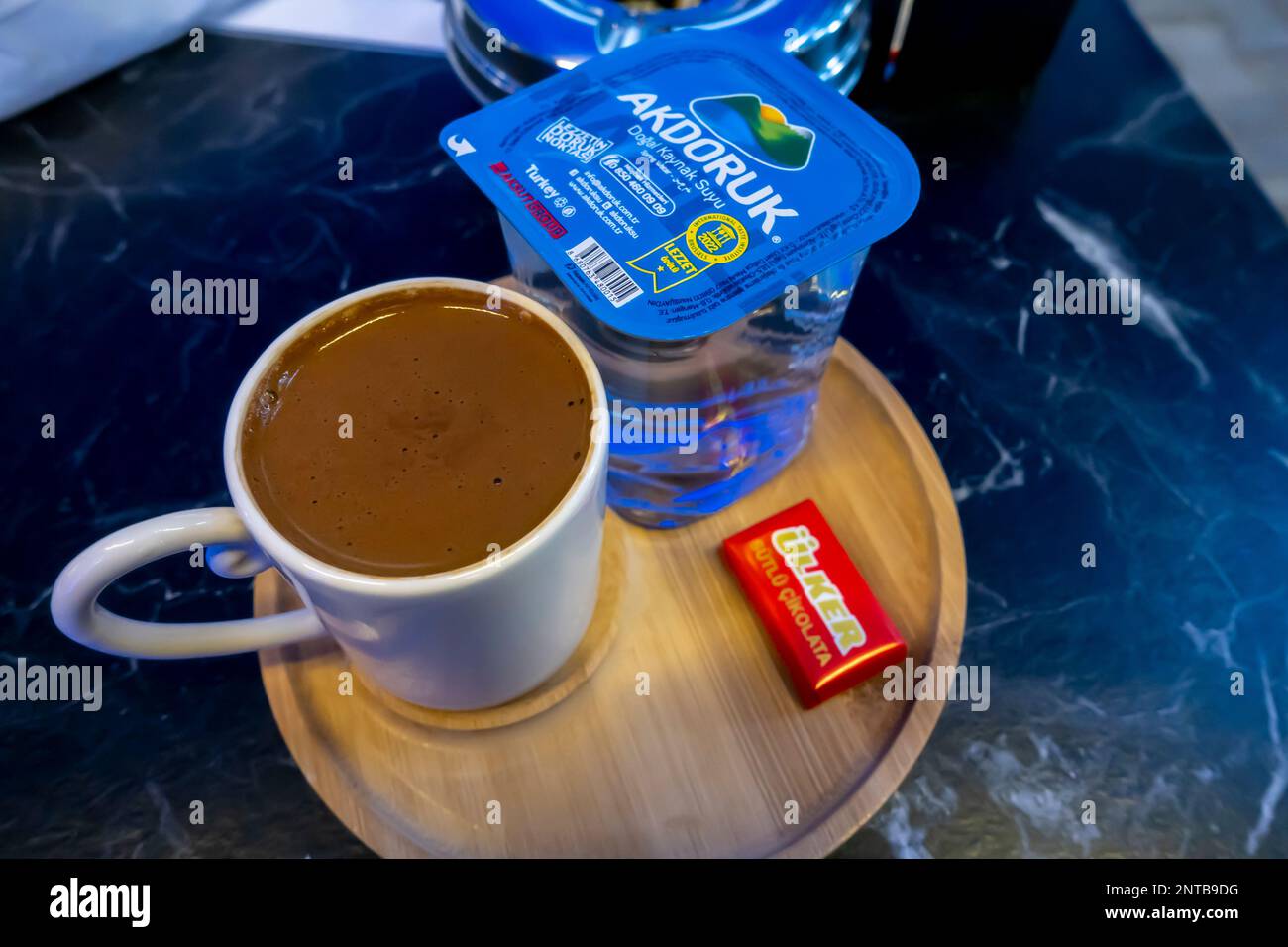 Turkish coffee served with a Ülker chocolate piece and Akdoruk pack of water. Street terrace ...