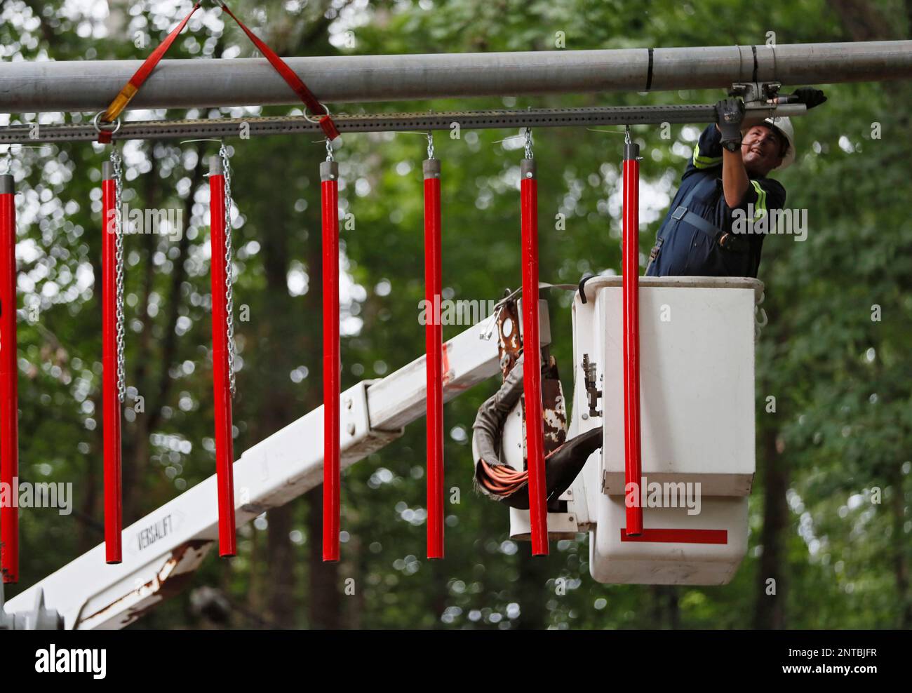 Roberto Jorge, a Cobb DOT worker, works on installing the PVC pipes ...