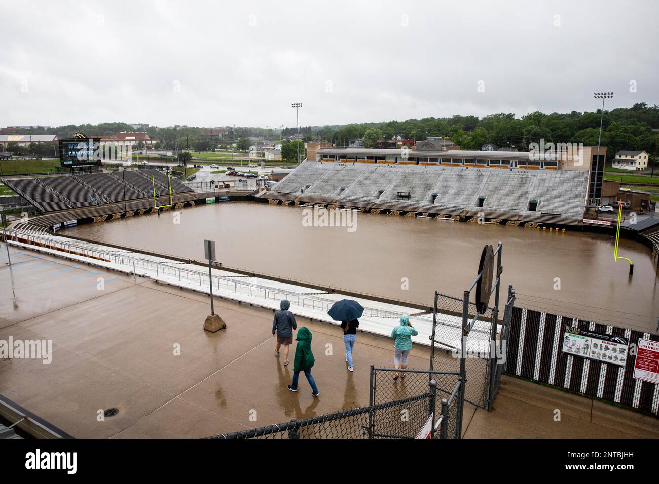People look at the flooded Waldo Stadium on the campus of Western ...