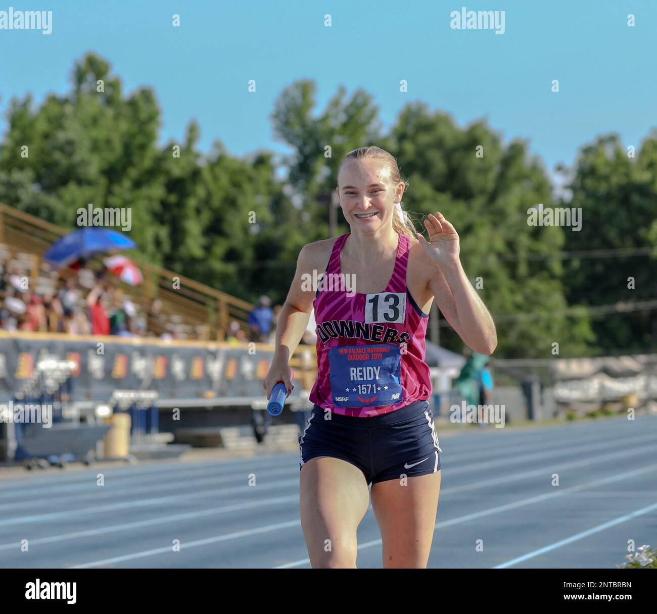 Erin Reidy, of Mustang TC, Connecticut, waves hello during the New ...