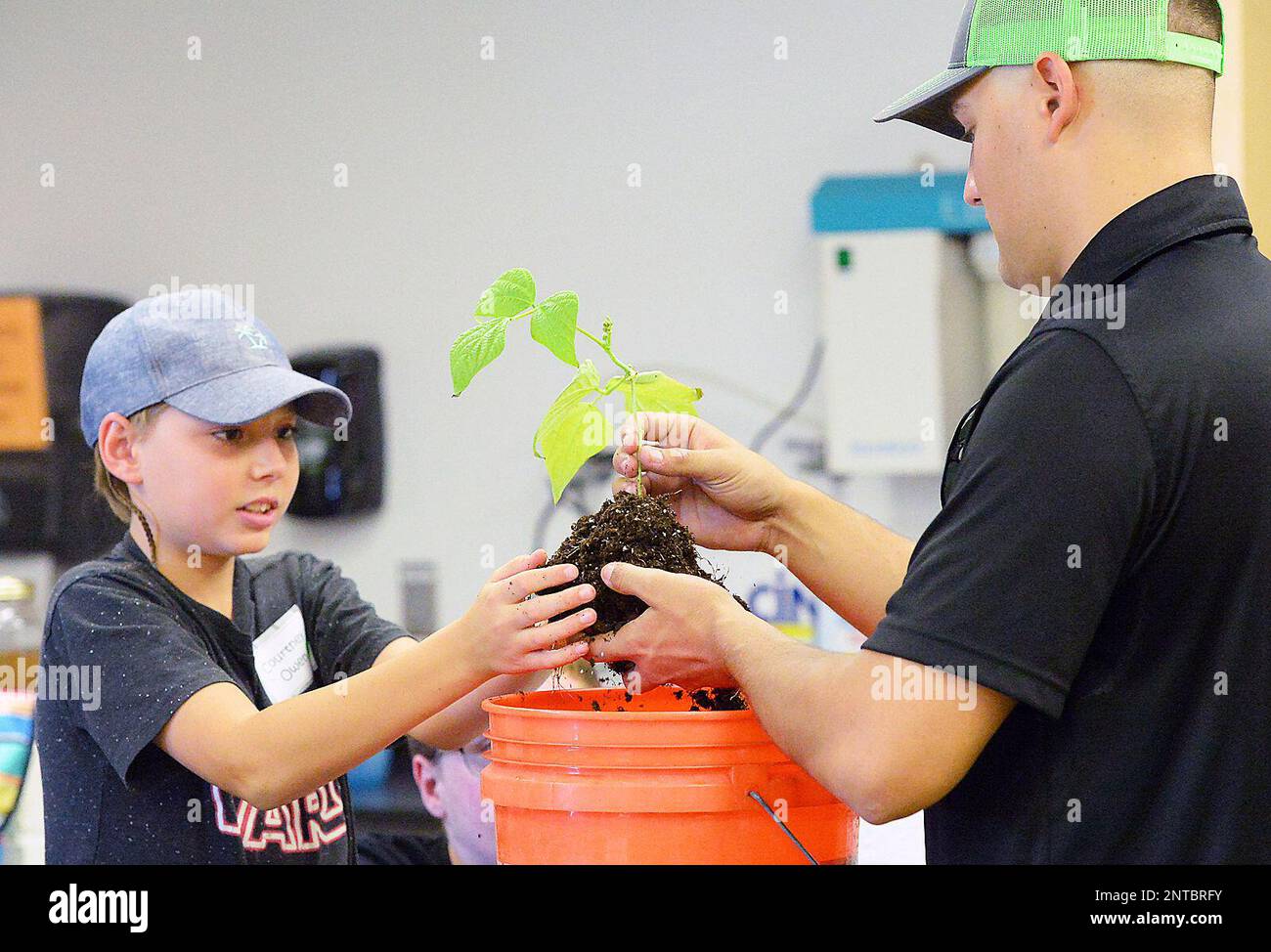 Arizona Western College lab technician Caleb Gillispie, right, helps ...