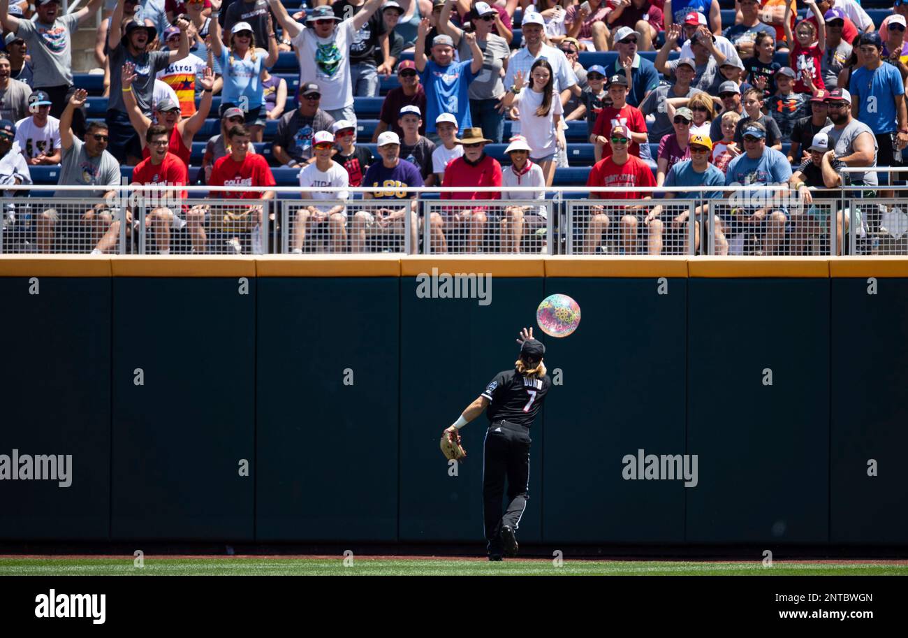 Louisville's Lucas Dunn throws a beach ball back to the crowd in the ...