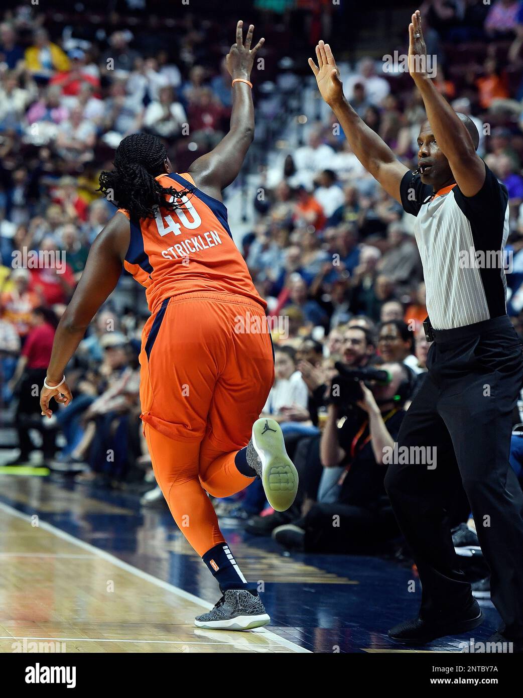 Connecticut Sun guard Shekinna Stricklen joins referee Eric Brewton in ...