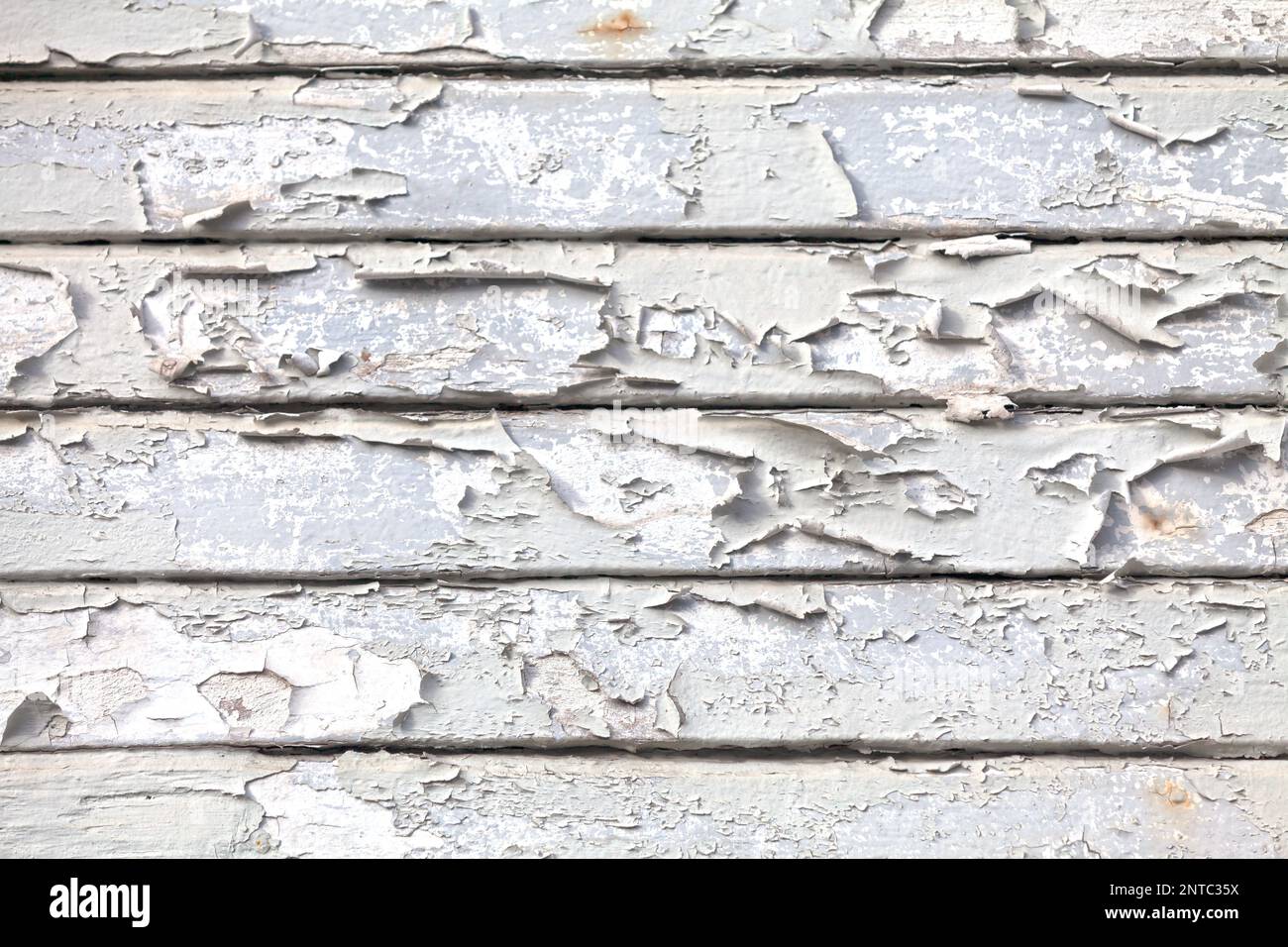 Close-up on an old white painted wooden board background with rusty ...