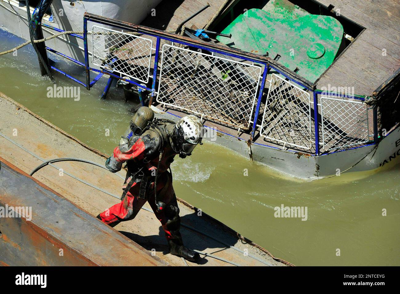 Sludge covers a diver's equipment during the recovery operation of the ...