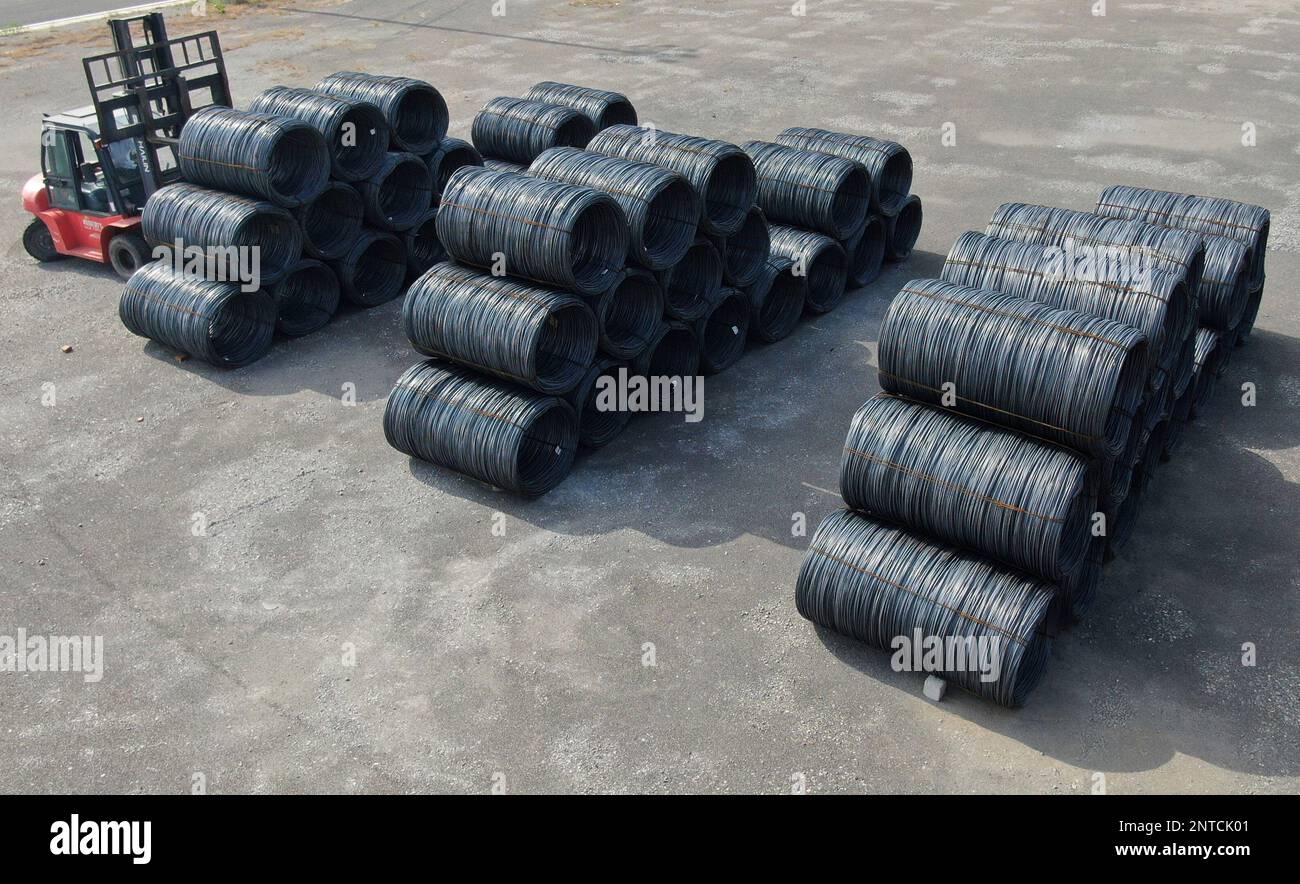 A forklift arranges rolls of rebar at a logistics base in Hai'an in ...