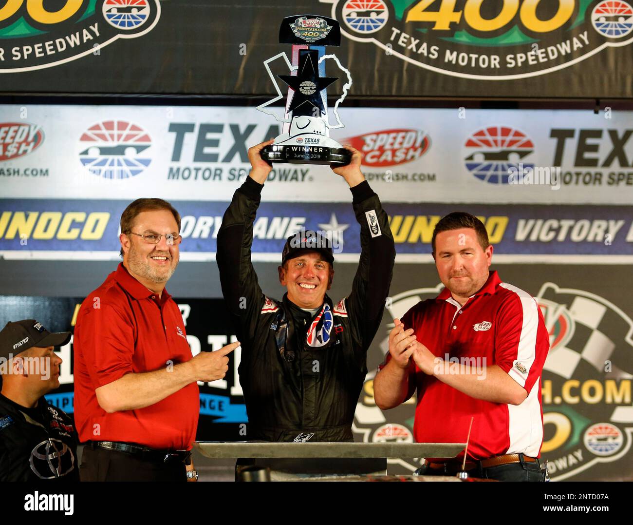 Greg Biffle raises the trophy after winning the NASCAR Truck Series ...