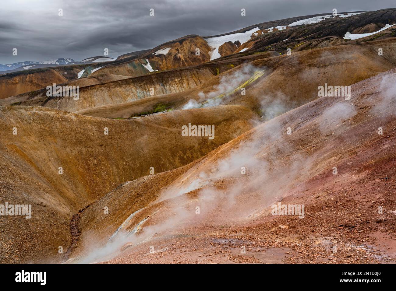 Steaming hot springs, colourful rhyolite mountains, volcanic landscape ...