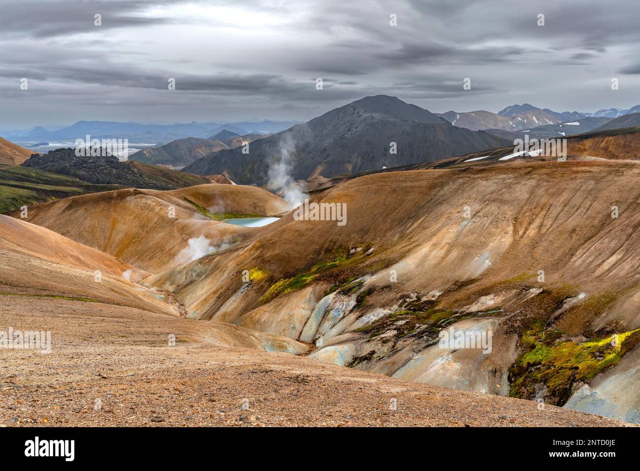 Steaming hot springs, colourful rhyolite mountains, volcanic landscape ...