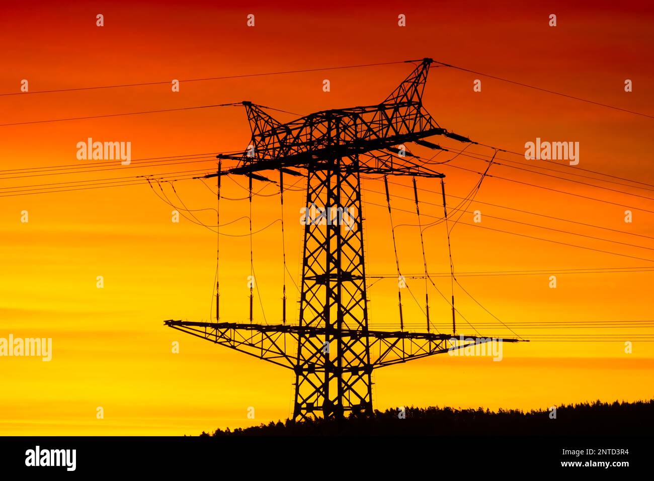 High-voltage pylon against fiery red sunrise Stock Photo - Alamy