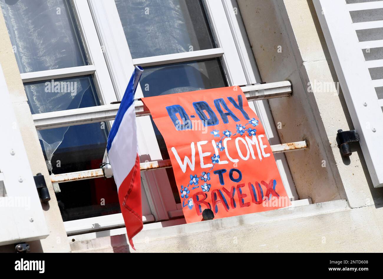 A placard is seen outside a window in front of the Cathedral of Bayeux ...