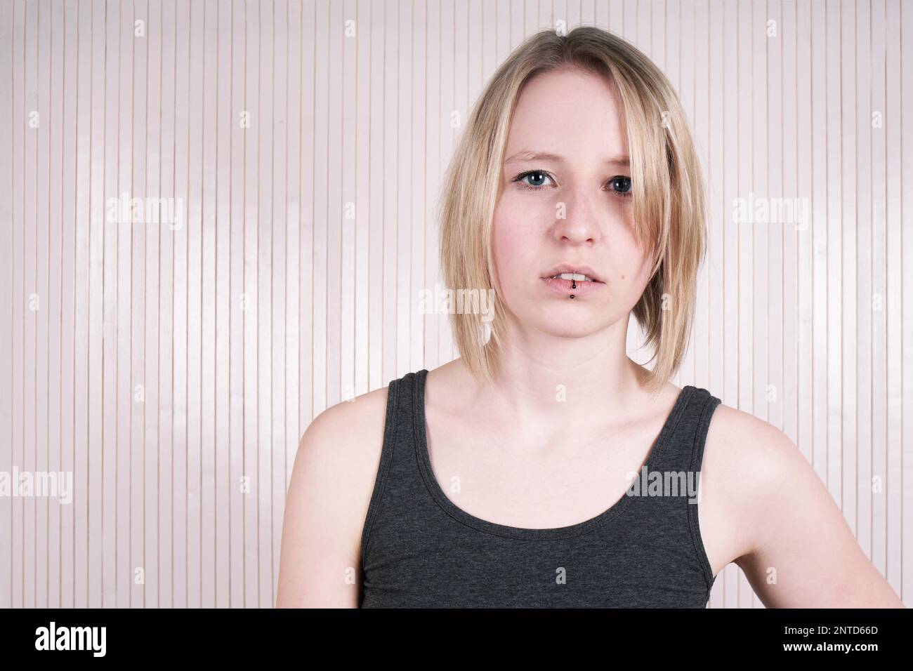 indoor portrait of a young woman from Germany with blond hair and blue ...