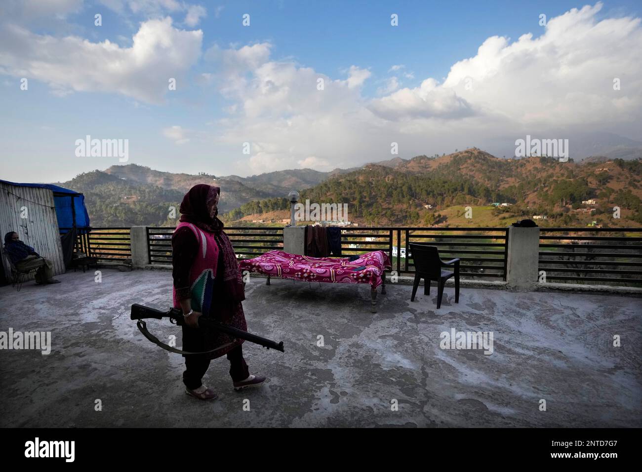 Village Defense Group member Usha Raina holding a gun stands on the ...
