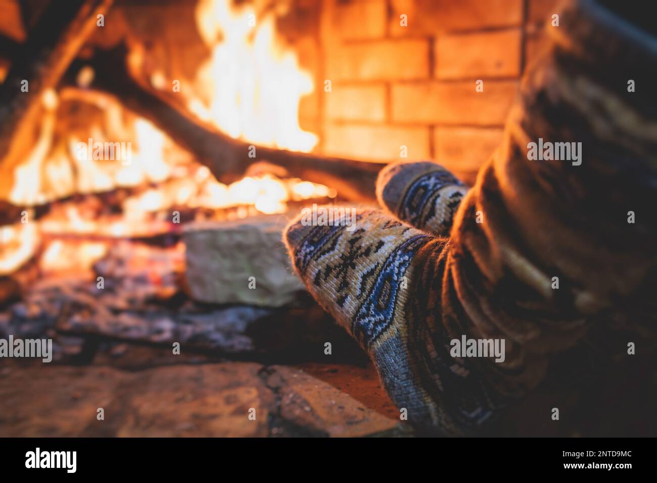 Warming up the fire, cozy winter night in the cabin house by the ...