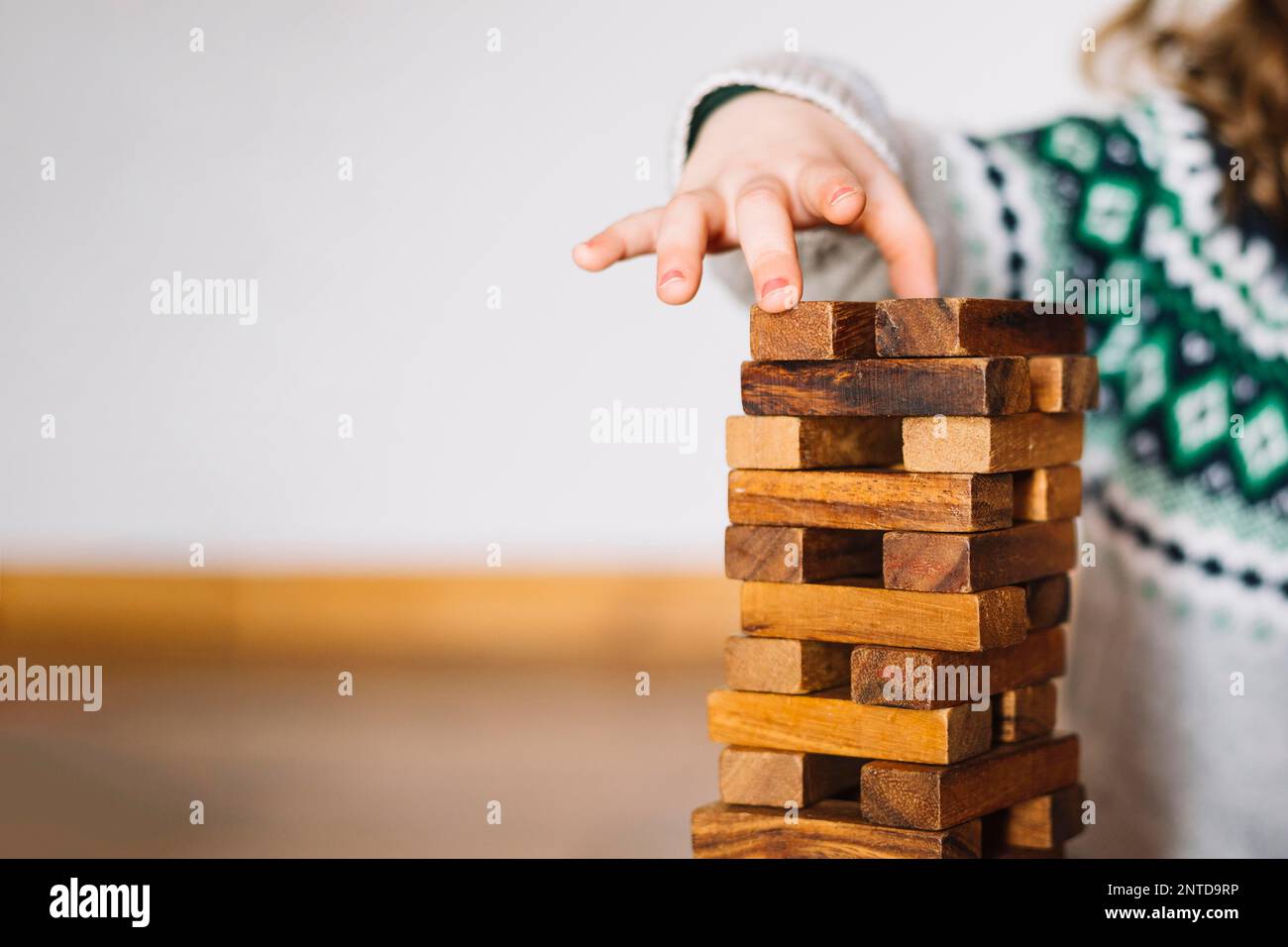 girl s hand stacking wooden blocks Stock Photo - Alamy