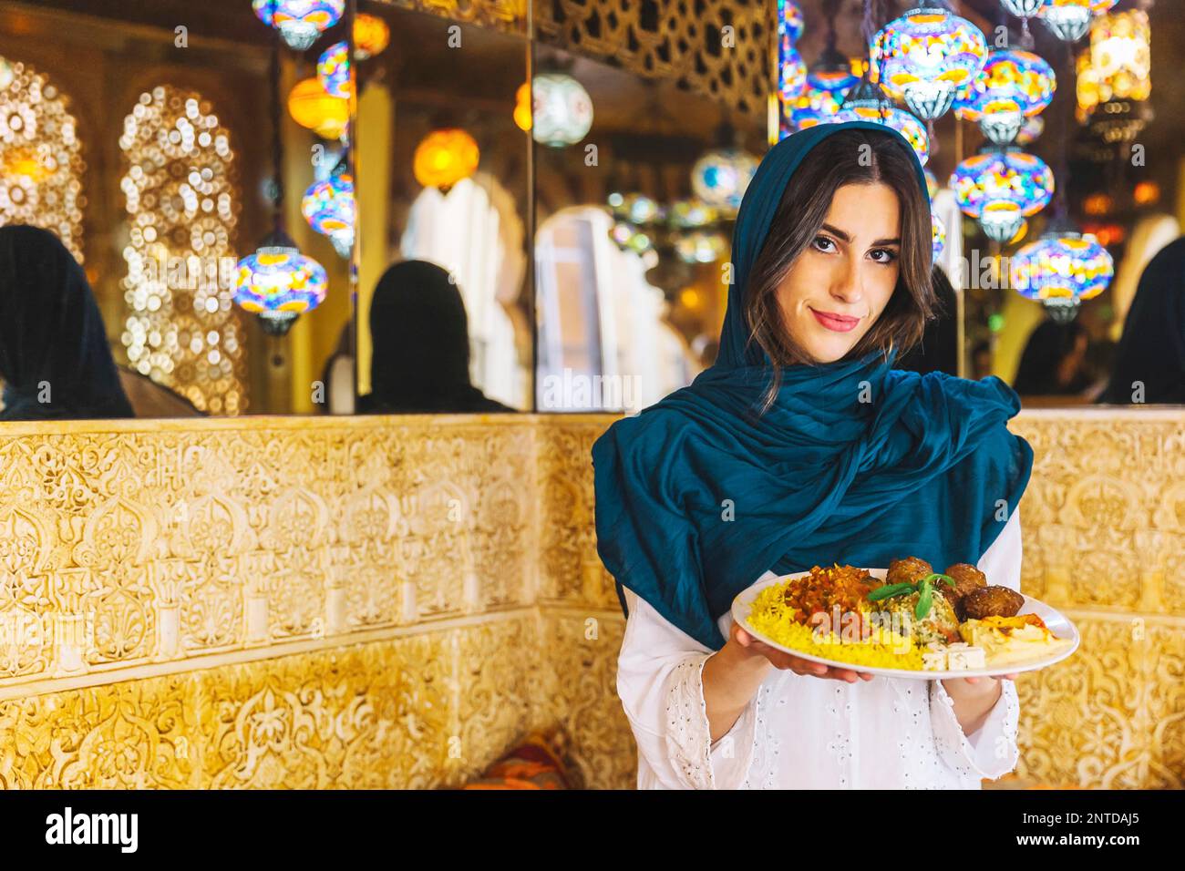 woman holding dish arab food Stock Photo - Alamy