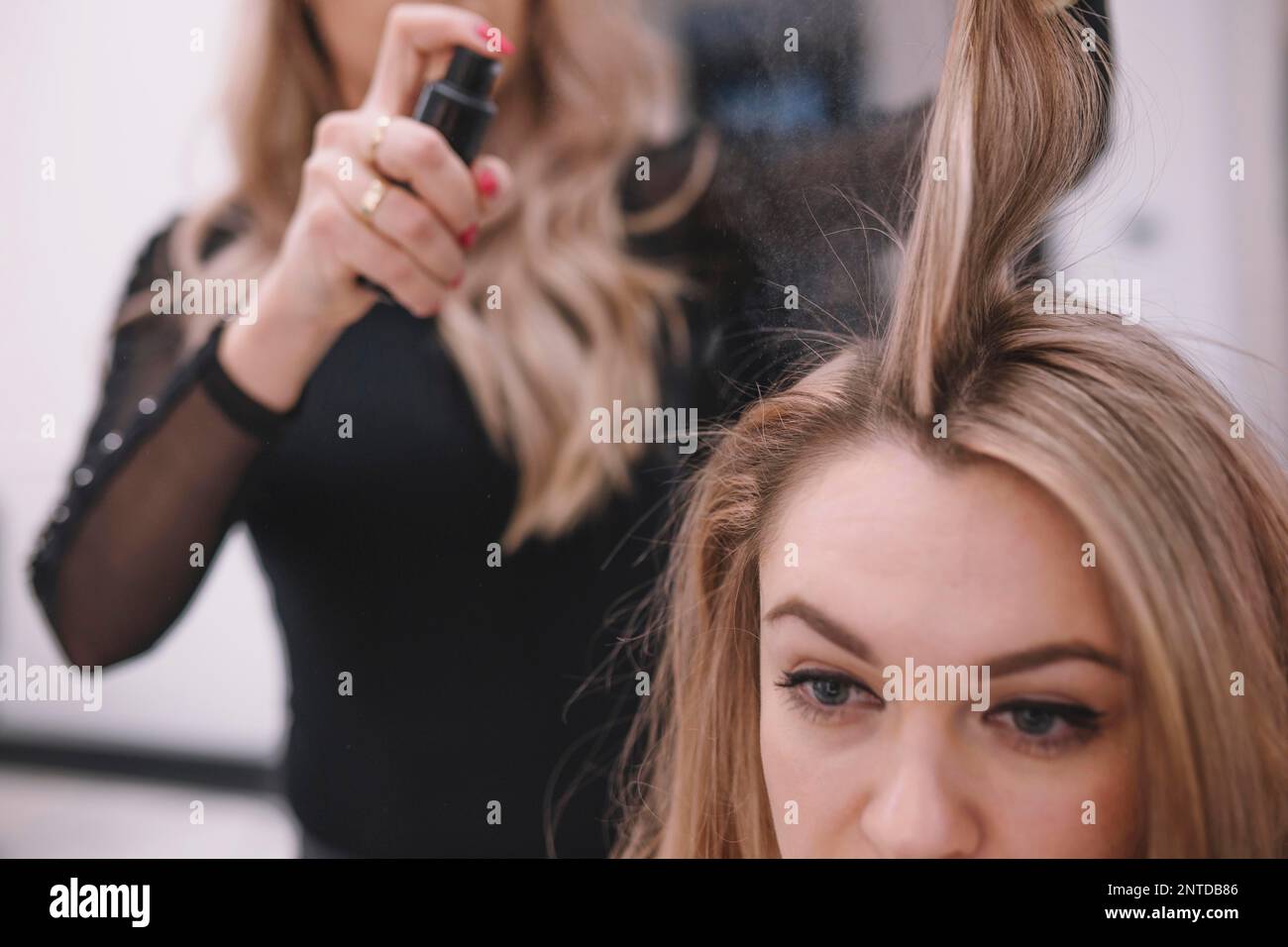 Hairdresser applying hair spray hi-res stock photography and images - Alamy