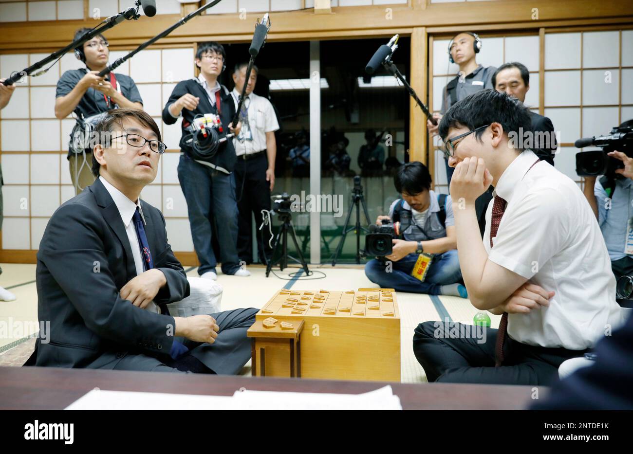 Japanese professional shogi player Yoshiharu Habu (L) reveiws his match ...
