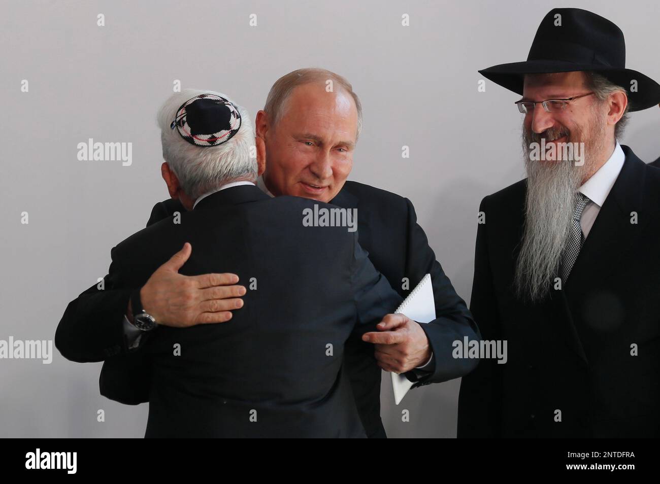 Russian President Vladimir Putin, center, embraces Aron Bell, a Polish ...