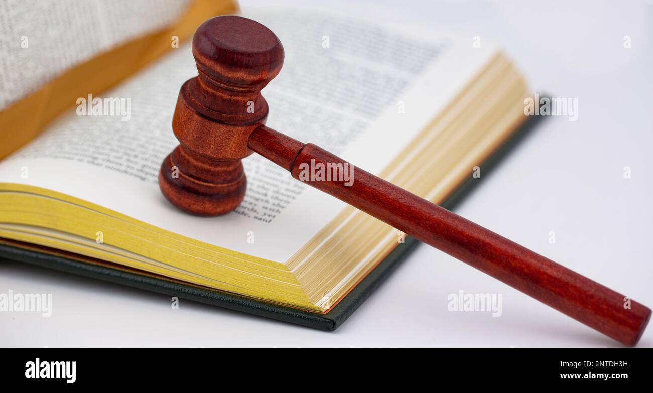 Book with gilt page edges and worn ribbon bookmark placed with polished ...