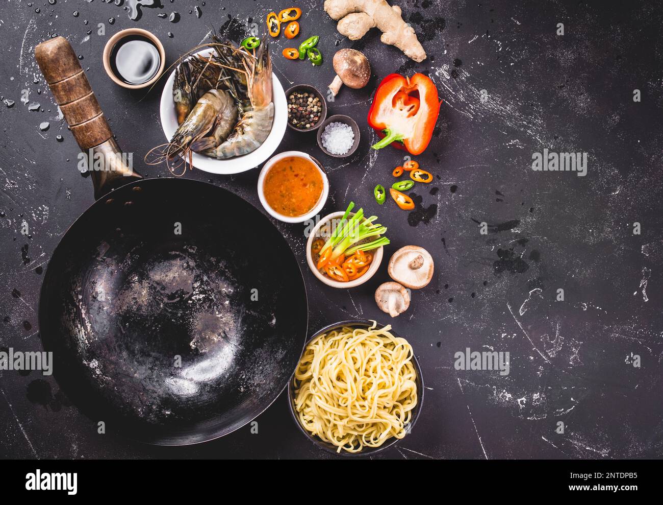 Asian food cooking concept, dark background. Empty wok pan, noodles ...