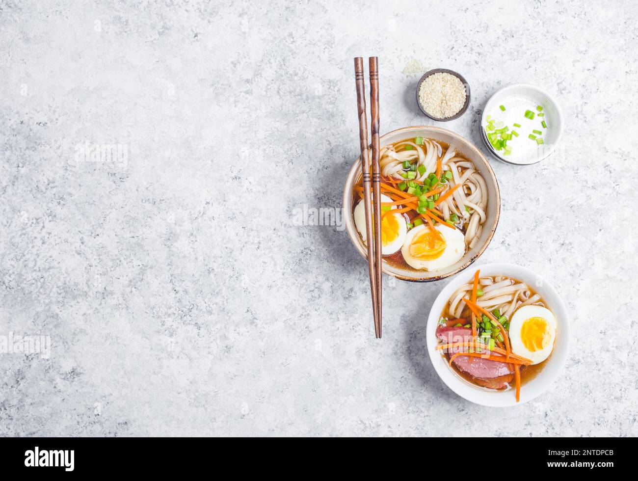 Bowls with Japanese soup ramen, chopsticks, white concrete rustic ...