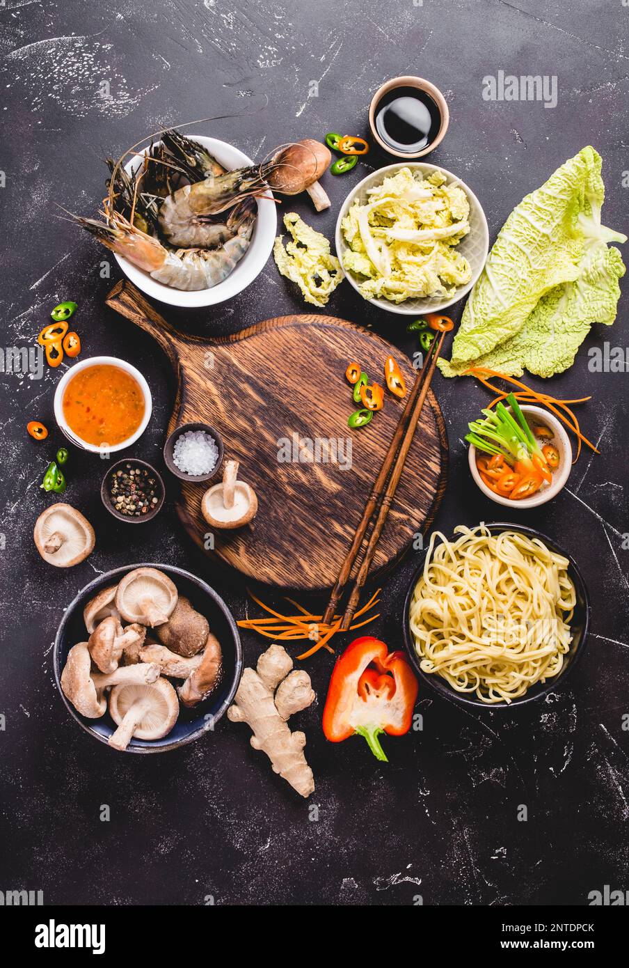 Asian food cooking concept. Empty wooden board, noodles, vegetables ...