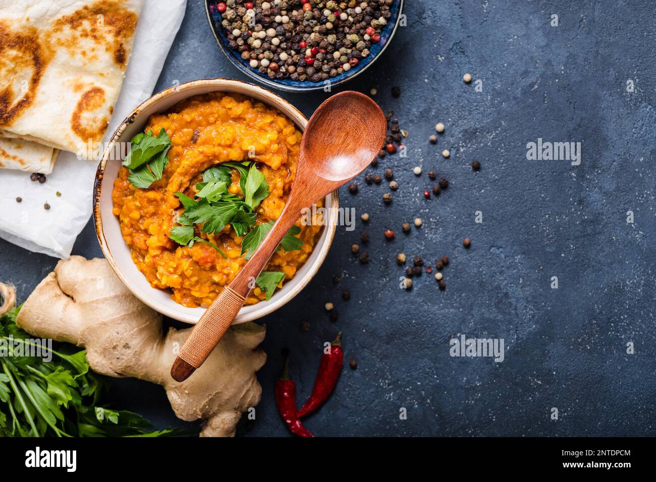 Traditional Indian lentils Dal, naan butter bread. Space for text ...