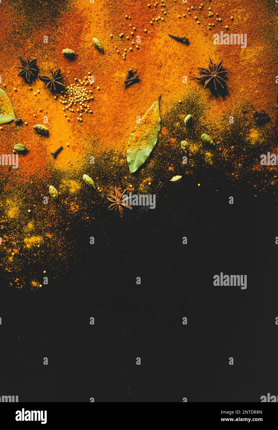 Assorted spices on dark black background. Seasonings for food. Space ...