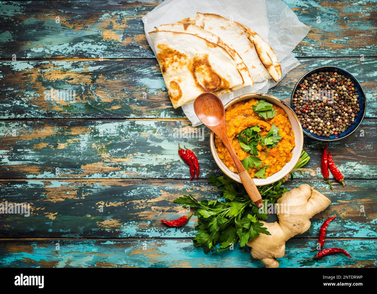 Traditional Indian lentils Dal, naan butter bread. Space for text ...
