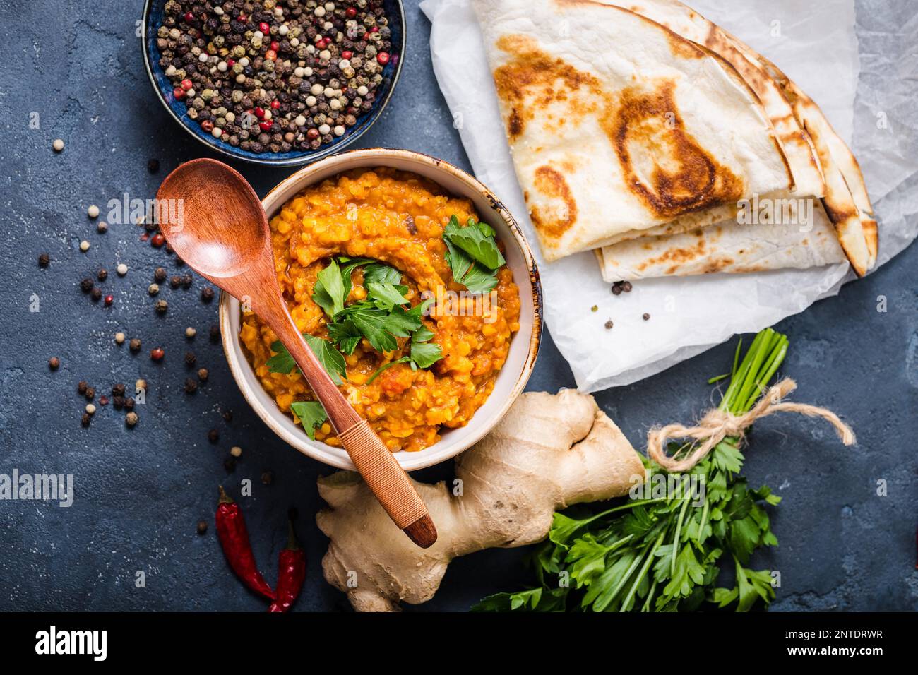 Traditional Indian lentils Dal, naan butter bread. Space for text ...