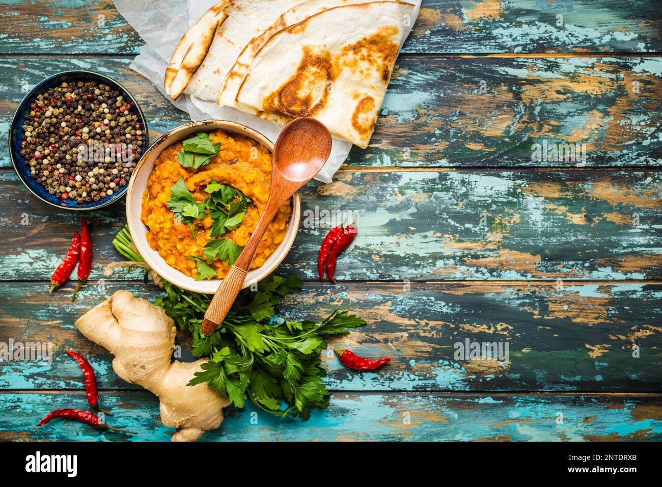 Traditional Indian lentils Dal, naan butter bread. Space for text ...