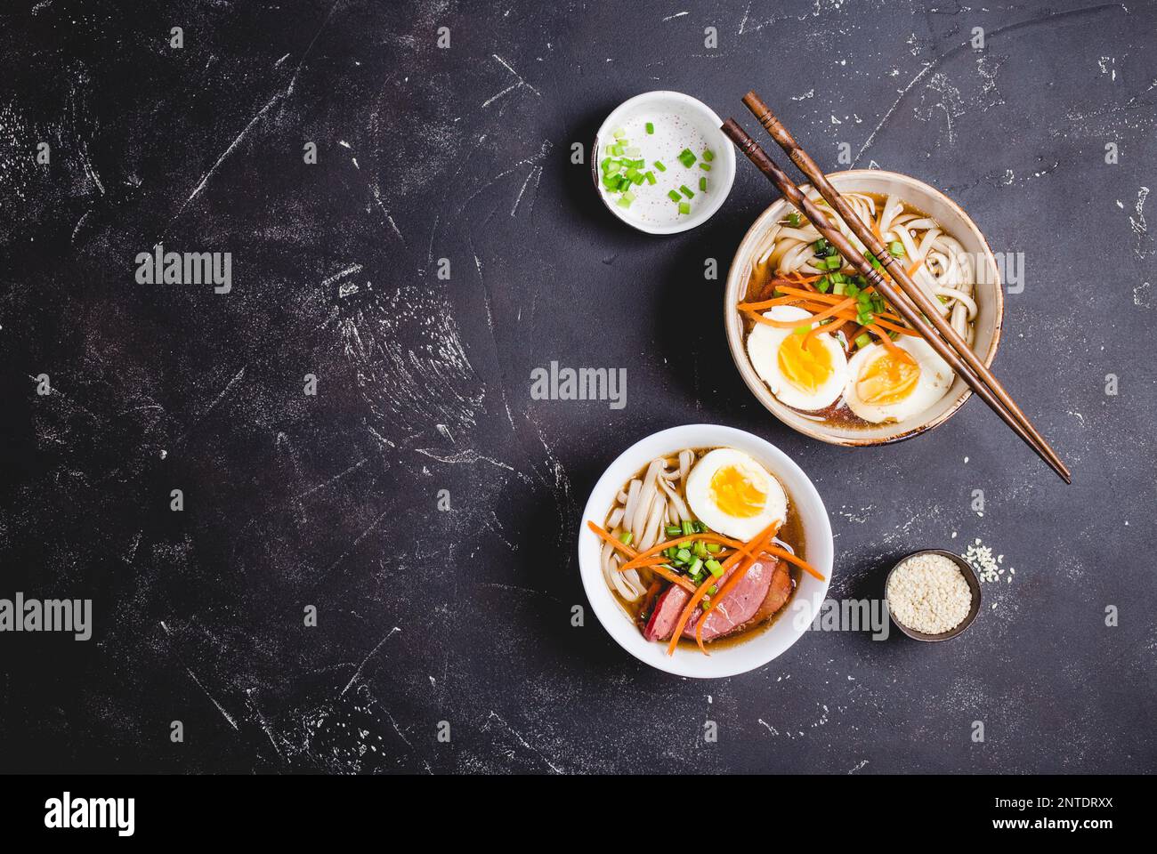 Bowls with Japanese soup ramen, chopsticks, black concrete rustic ...