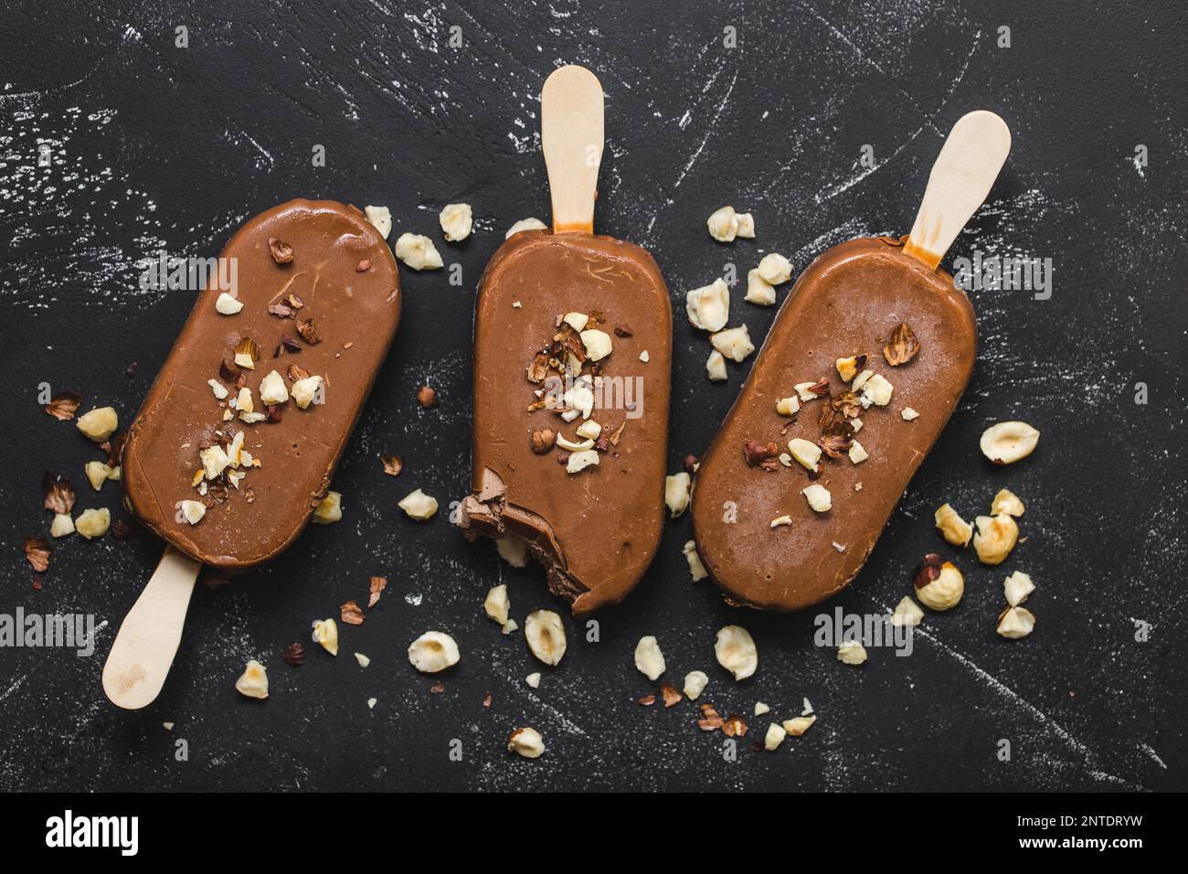 Milk chocolate popsicles with hazelnuts. Close-up. Ice cream popsicles ...