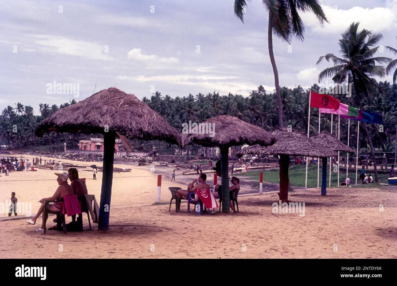 Kovalam, stretches of golden sand beach, fringed by coconut palms, very ...