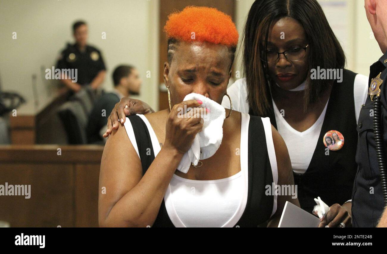 Cecille Bennett Downy, right, consoles her sister Carol Bennett as she ...