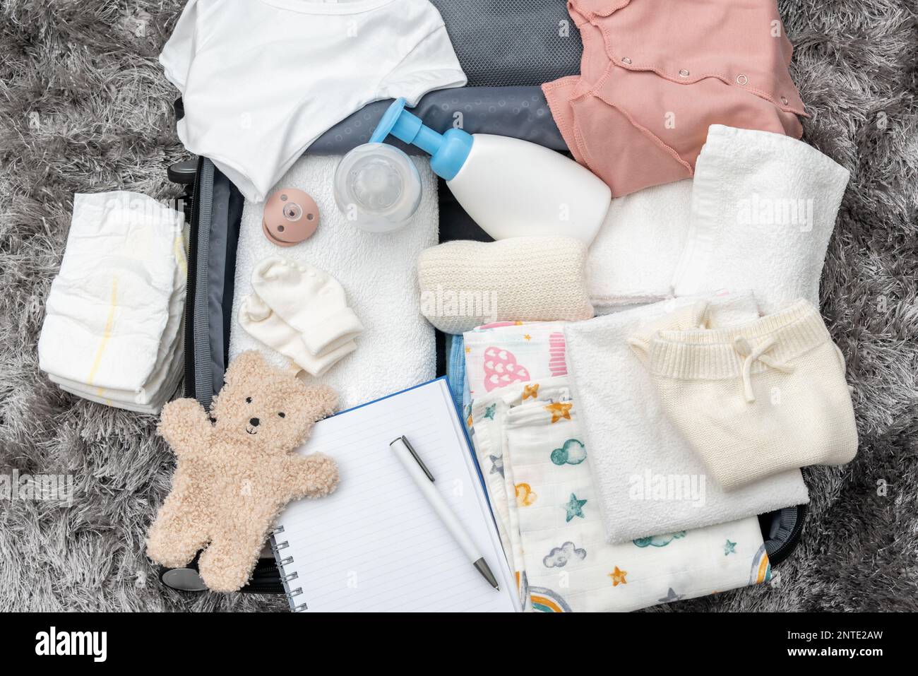 Open bag for maternity hospital on the floor. Suitcase with baby ...
