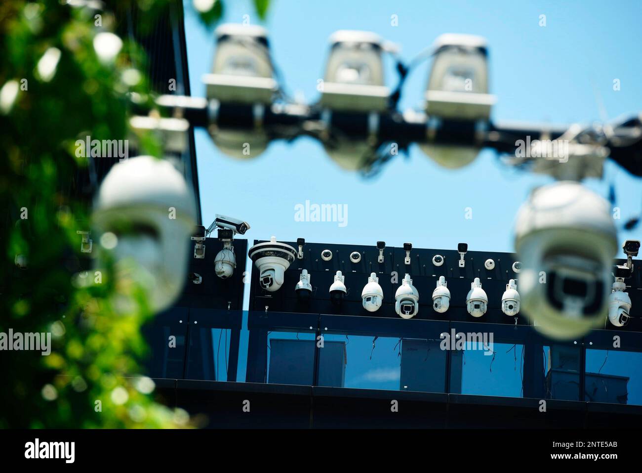 A view of dozens of surveillance cameras on the office building of ...