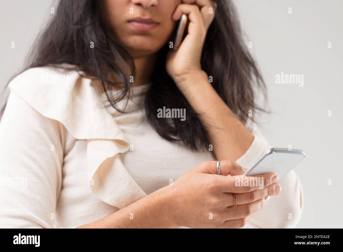 Close focus on the hand of a young woman clutching a smartphone on ...