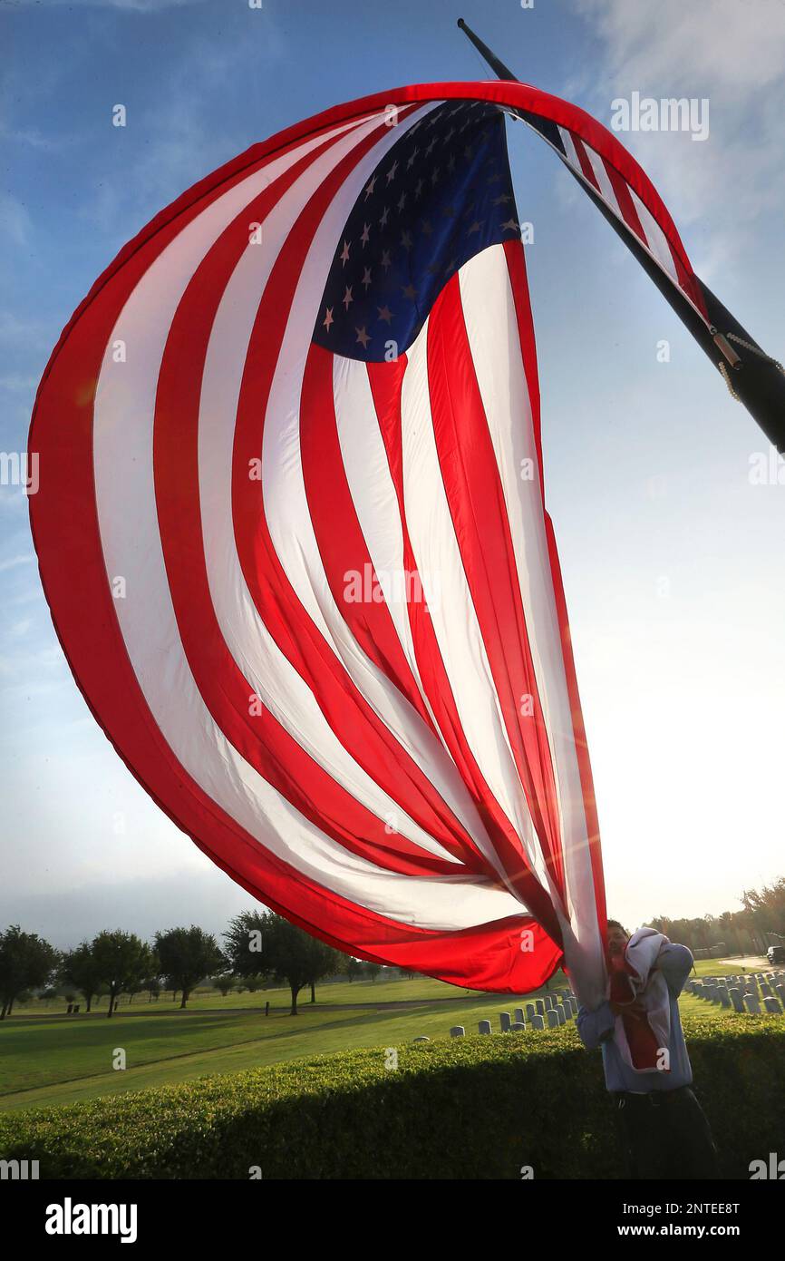 JC Mata and Rene Hinojosa place a Texas-sized flag at Rio Grande Valley ...