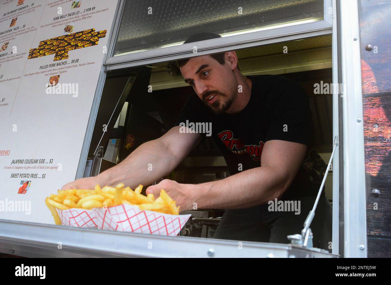 Anthony Commisso, of Grumpy's BBQ, Mechanicsville, Pa., waits on a ...