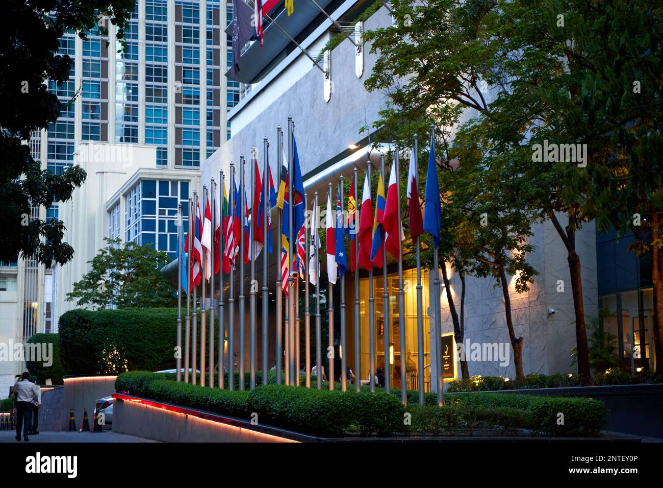 This photo features a row of tall poles with flags from different ...